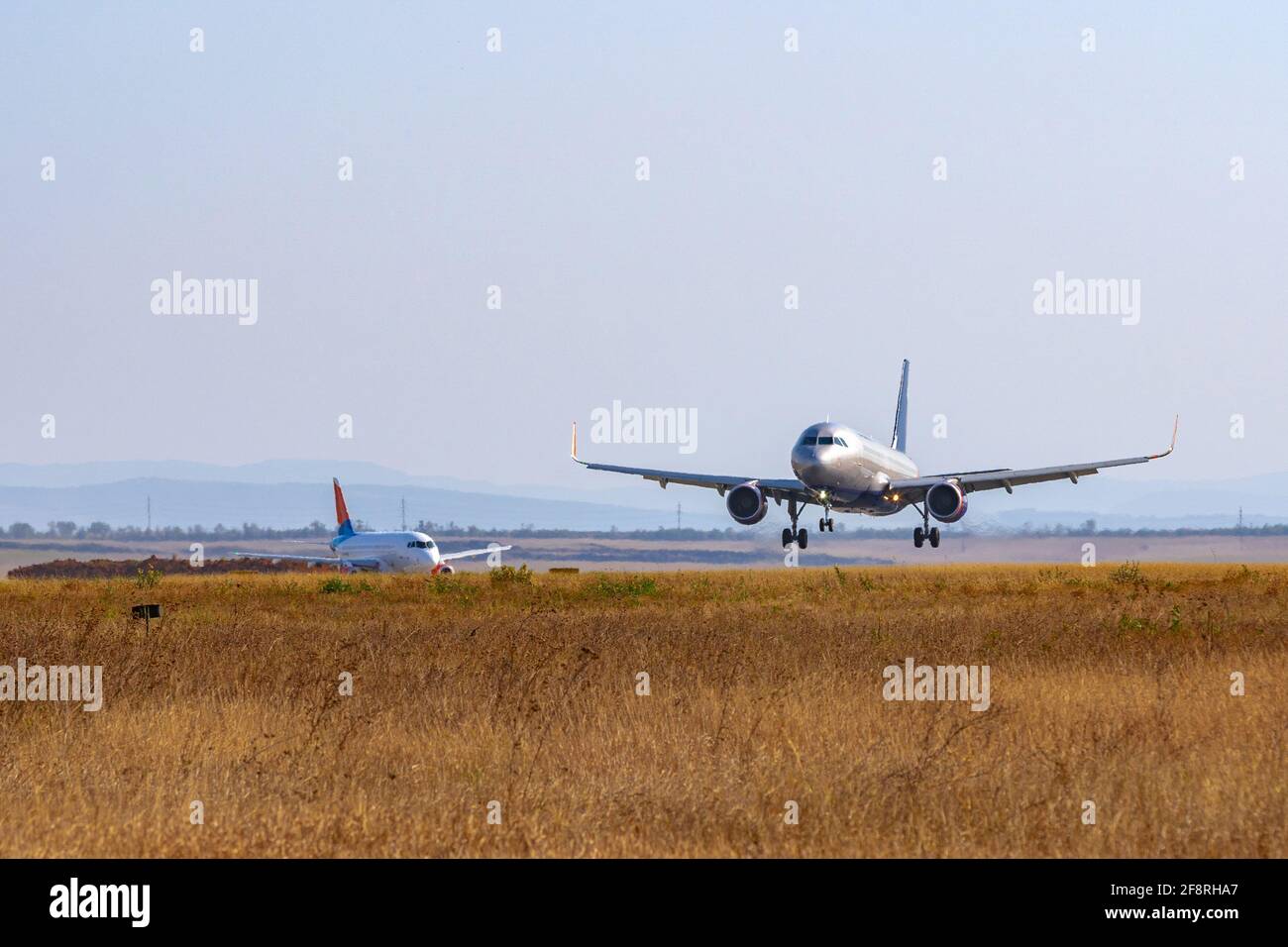 Passenger plane takes off from runway in airport Stock Photo - Alamy