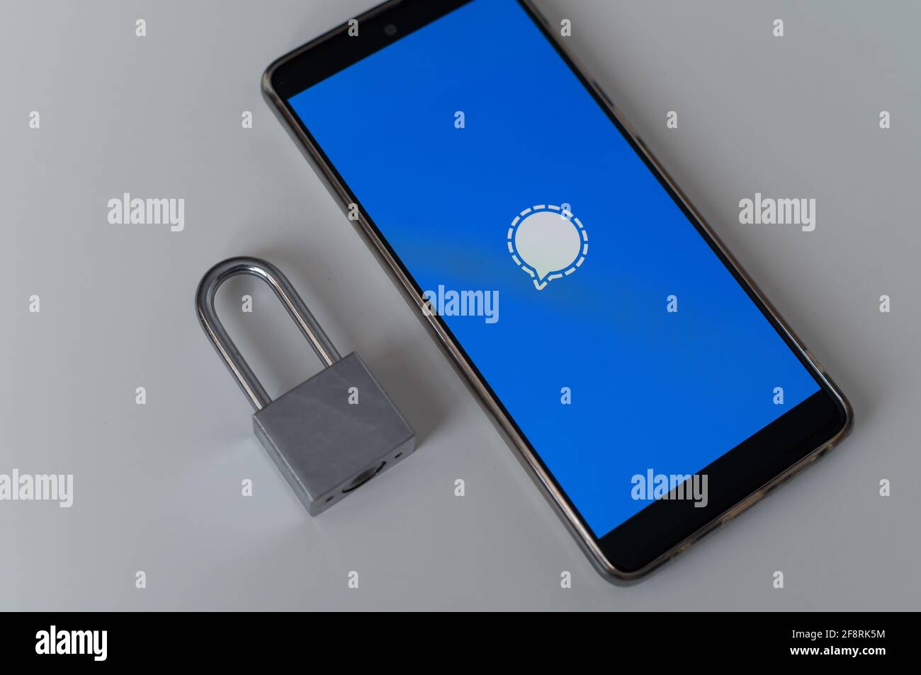 Mobile phone with messenger logo signal and lock on white background ...