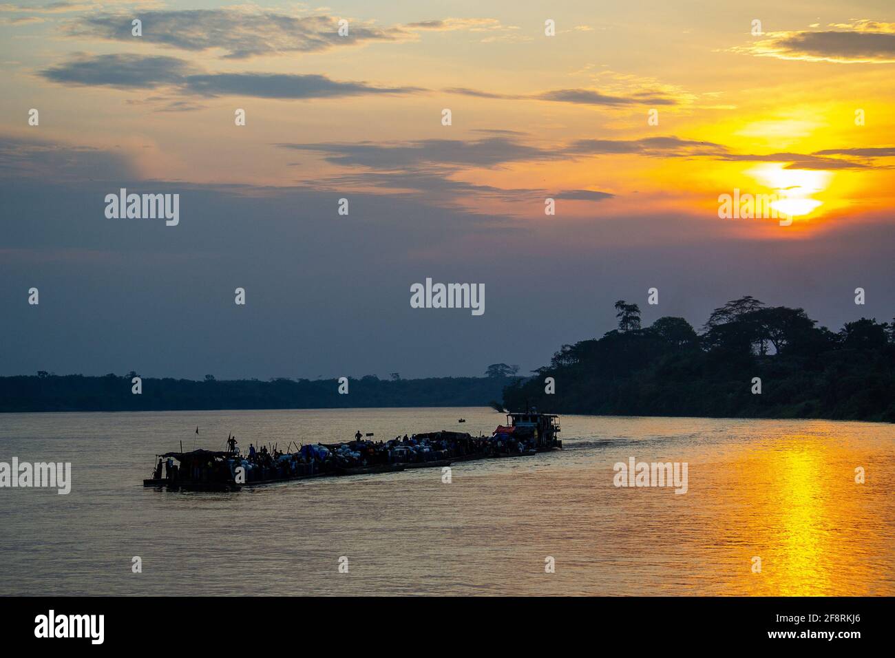 Barge departing Kisangani at sunset, travelling down the Congo river to ...