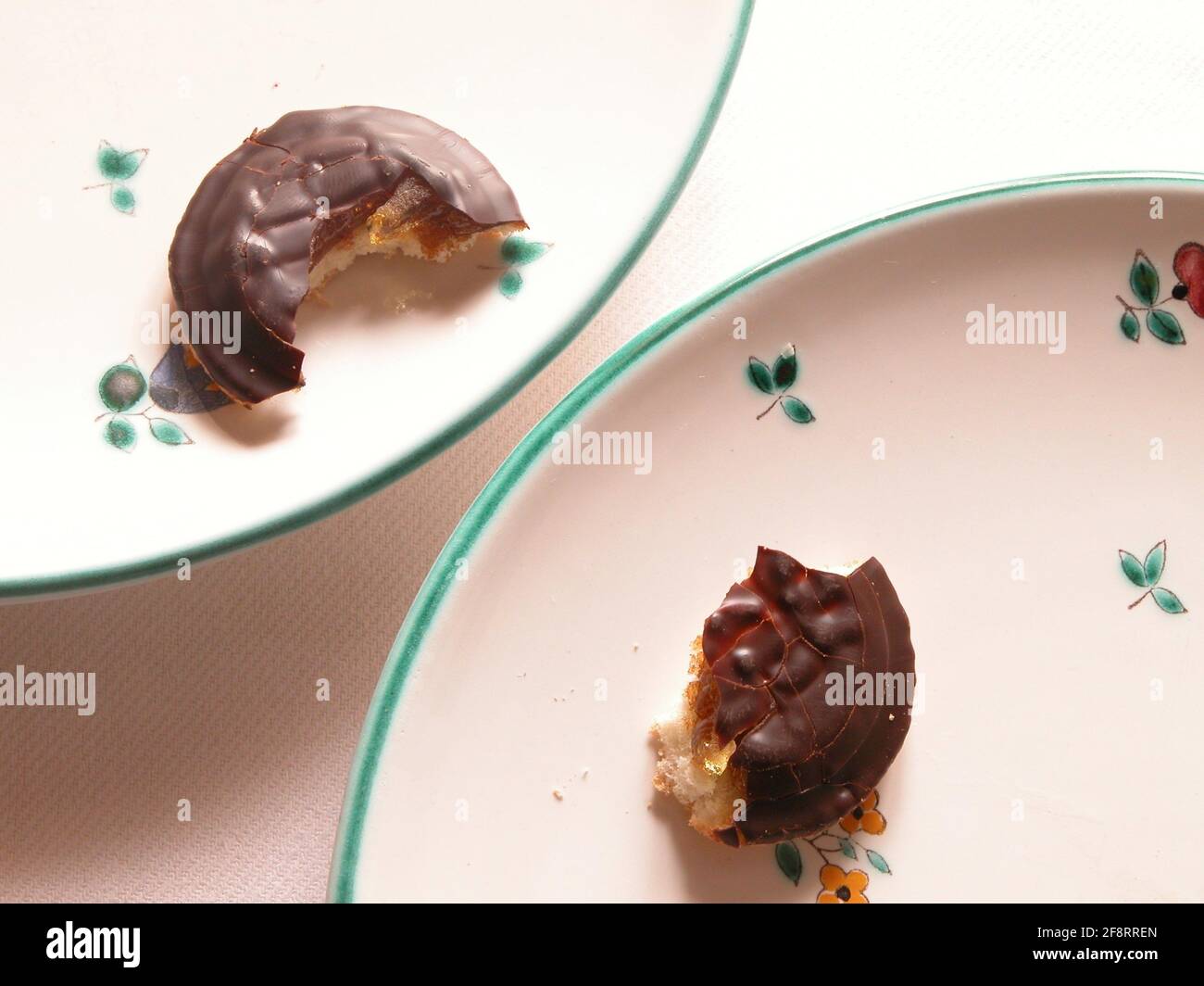 two plates with a split cookie Stock Photo - Alamy