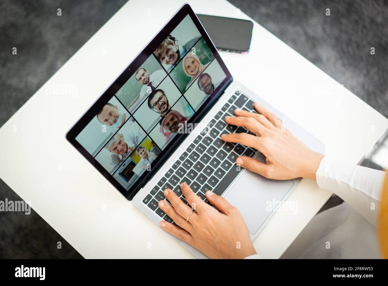 Online business conference screen in hands new normal Stock Photo - Alamy