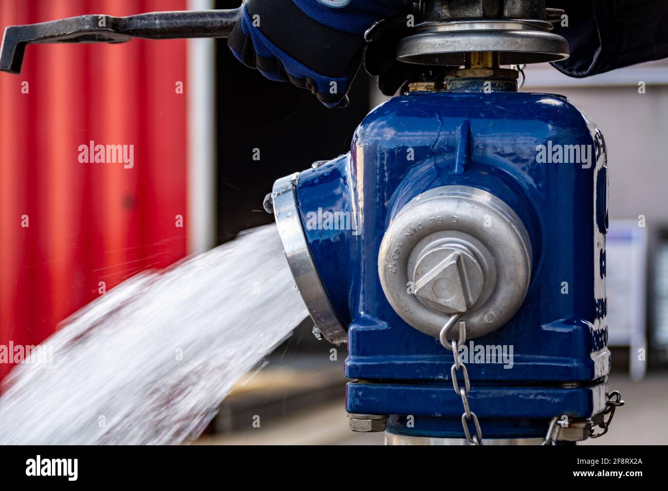 Close up of Water flowing from in open blue fire hydrant Stock Photo ...