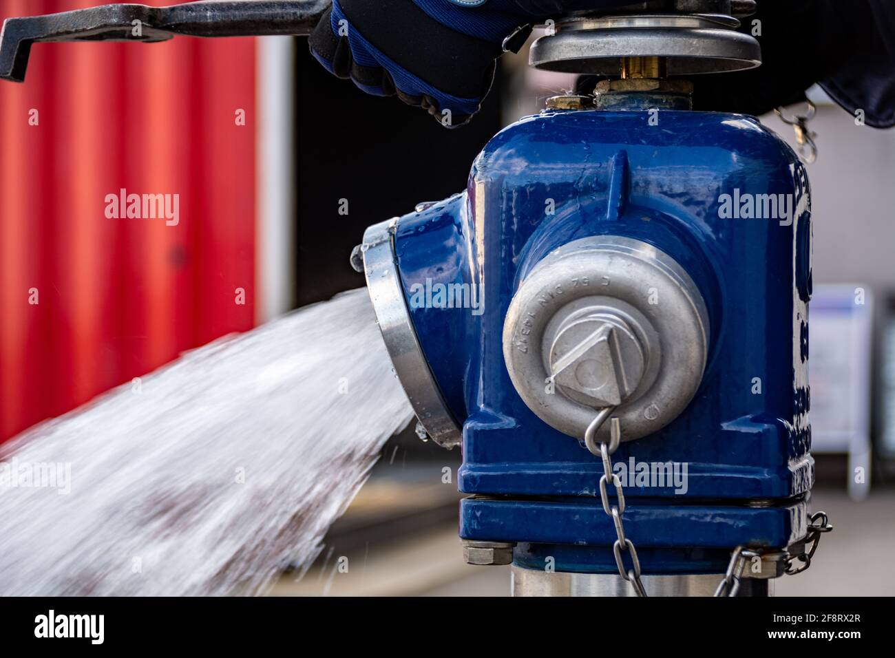 Close up of Water flowing from in open blue fire hydrant Stock Photo ...