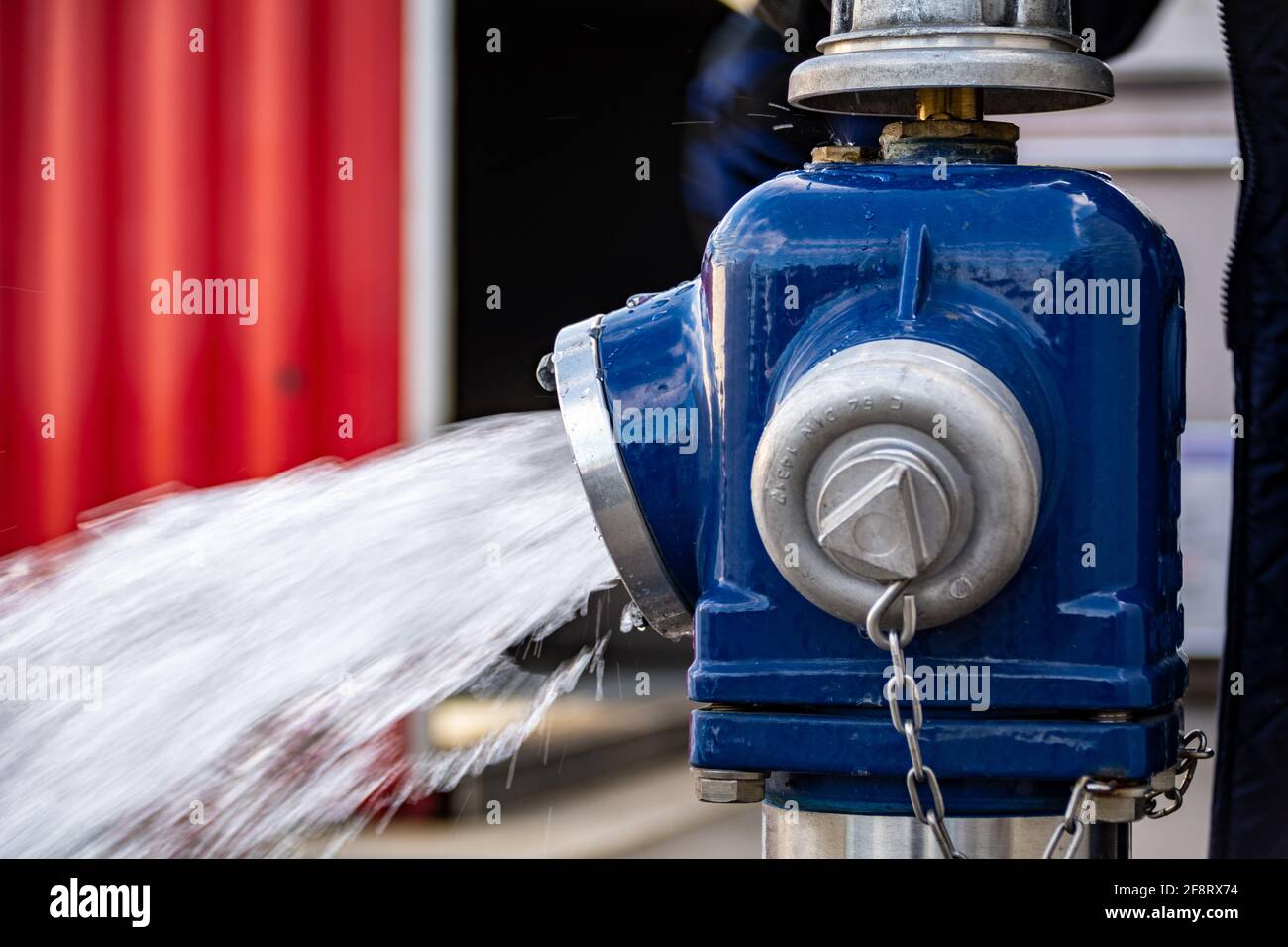 Close up of Water flowing from in open blue fire hydrant Stock Photo ...