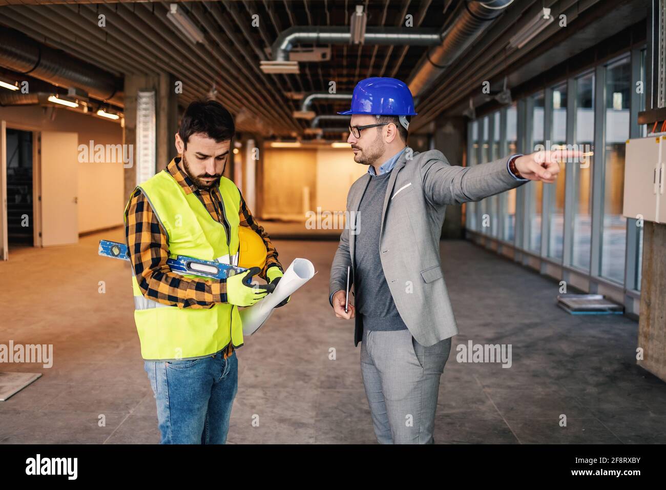 Angry supervisor getting fired construction worker. Construction site ...