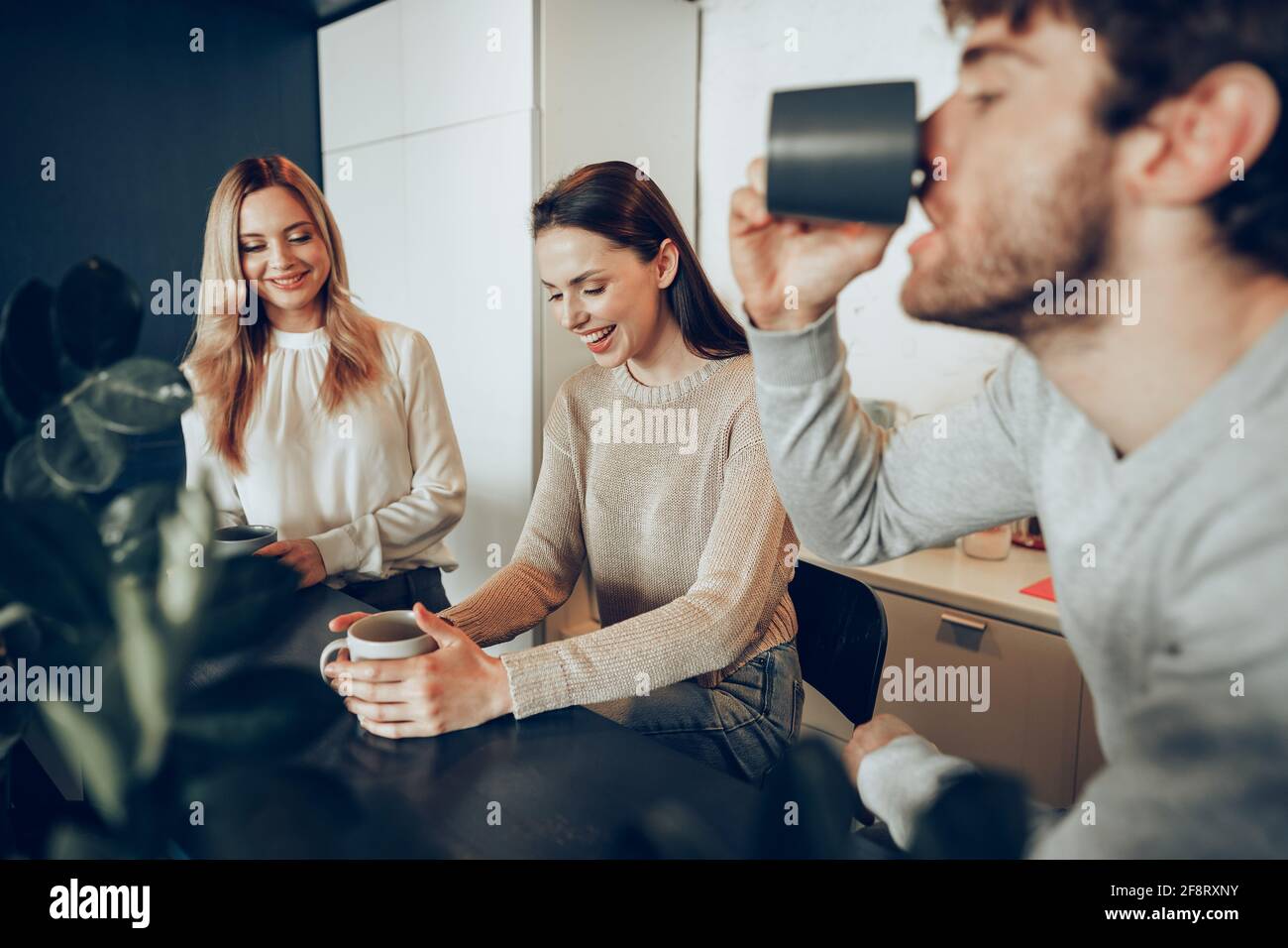 Young businesspeople colleagues having a coffee break in office ...