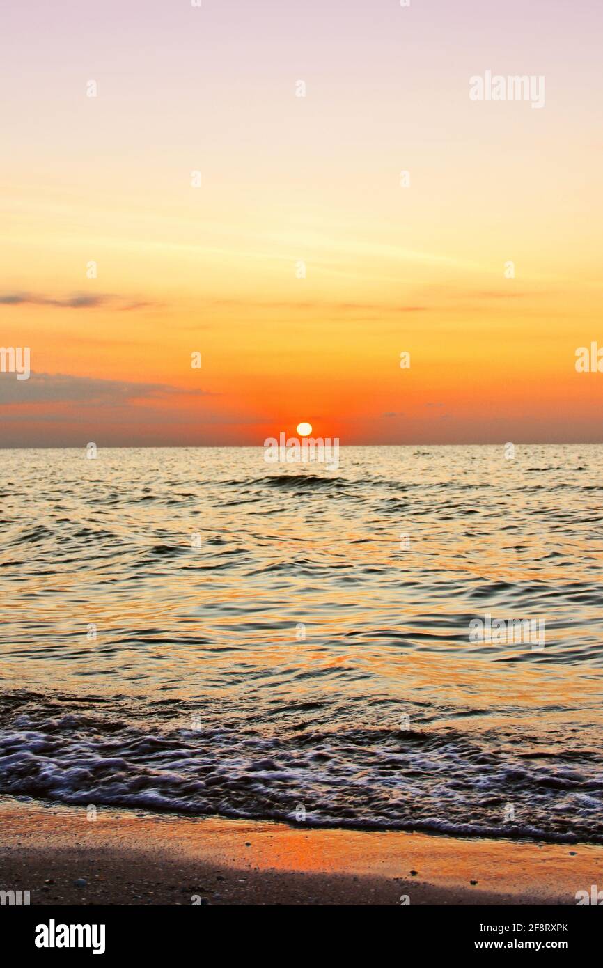 Beautiful sunset at the sea. The sea in the foreground. Background ...