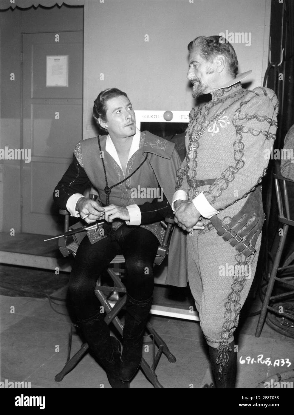 ERROL FLYNN and ROBERT WARWICK on set candid during filming of ...