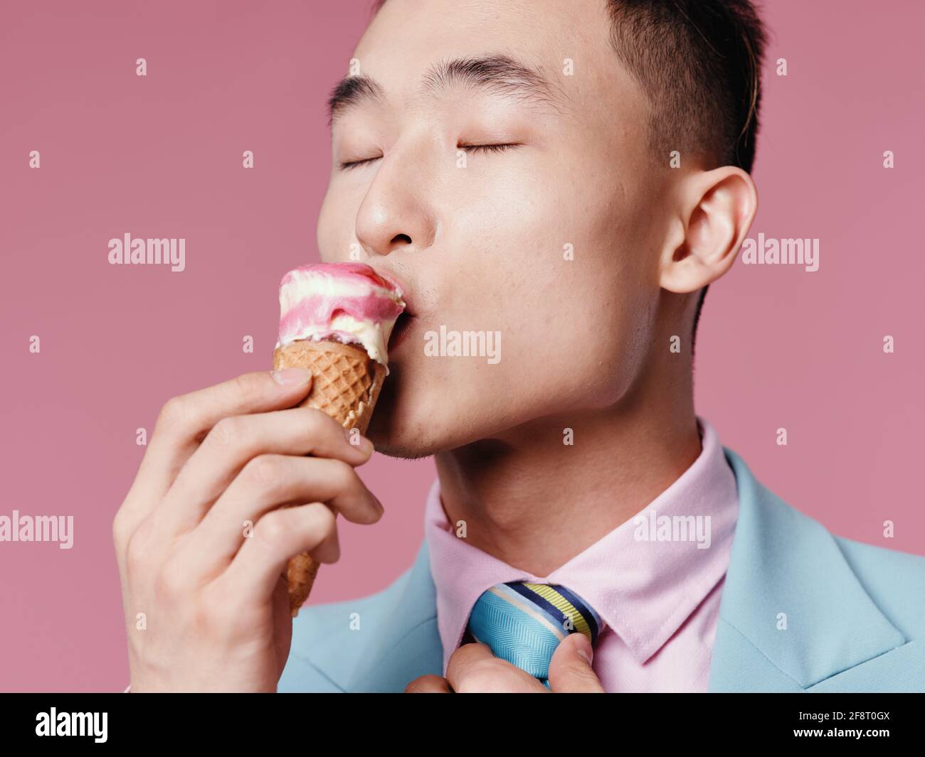 man eating delicious ice cream on pink background enjoyment Stock Photo ...