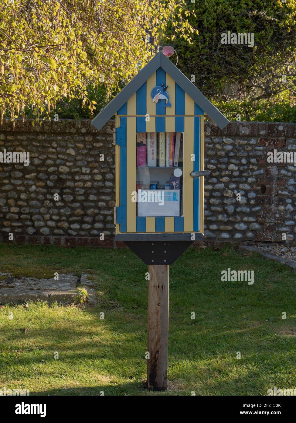 Small colourful book box seen outside in the UK Stock Photo - Alamy