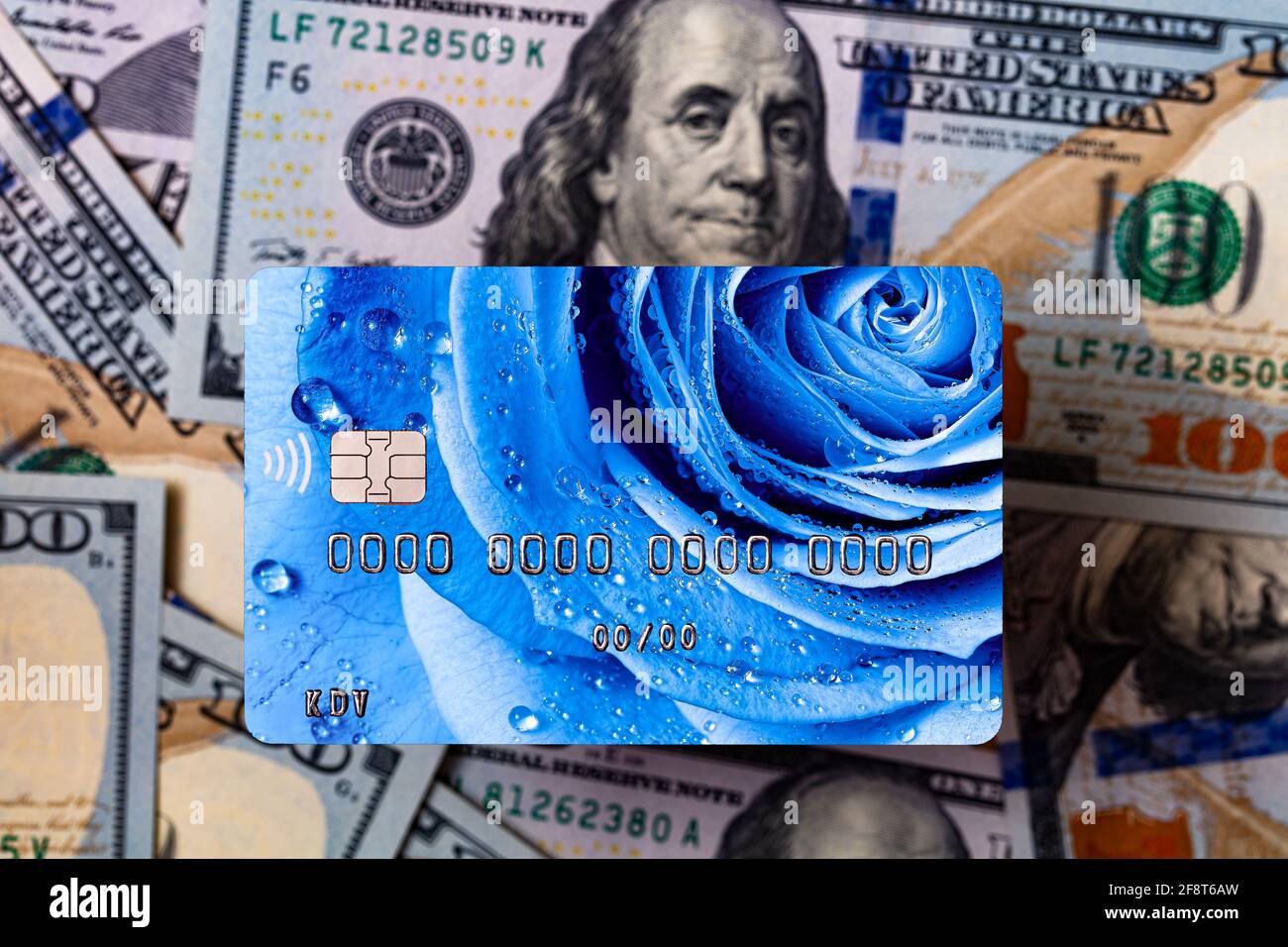 Debit card with rose design on US 100 dollar banknotes background for ...