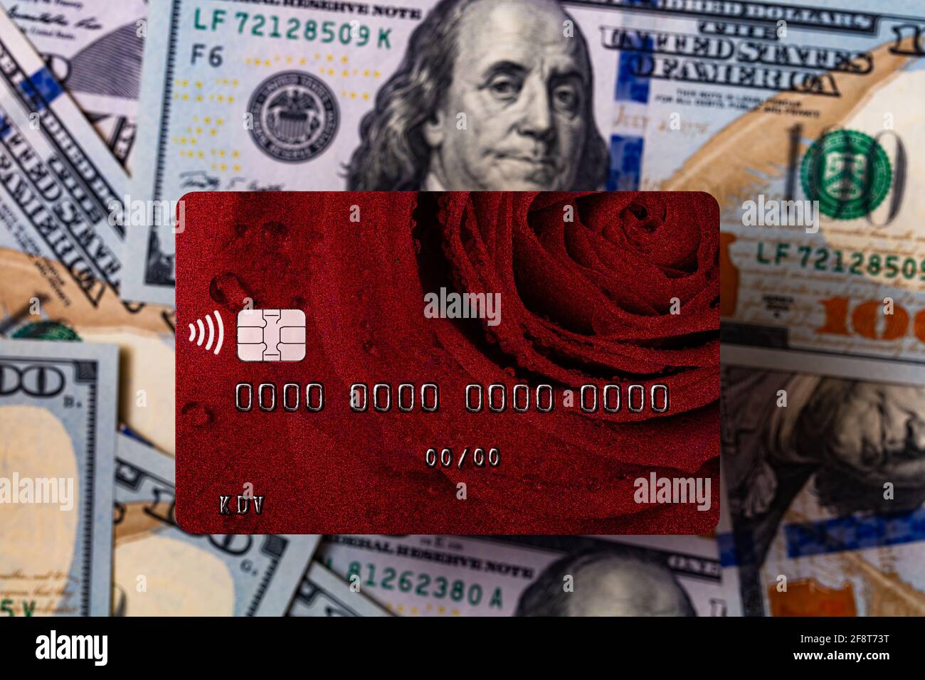 Debit card with rose design on US 100 dollar banknotes background for ...