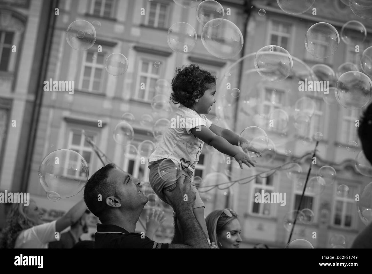 Happy and proud father having fun with his daughter in the city ...