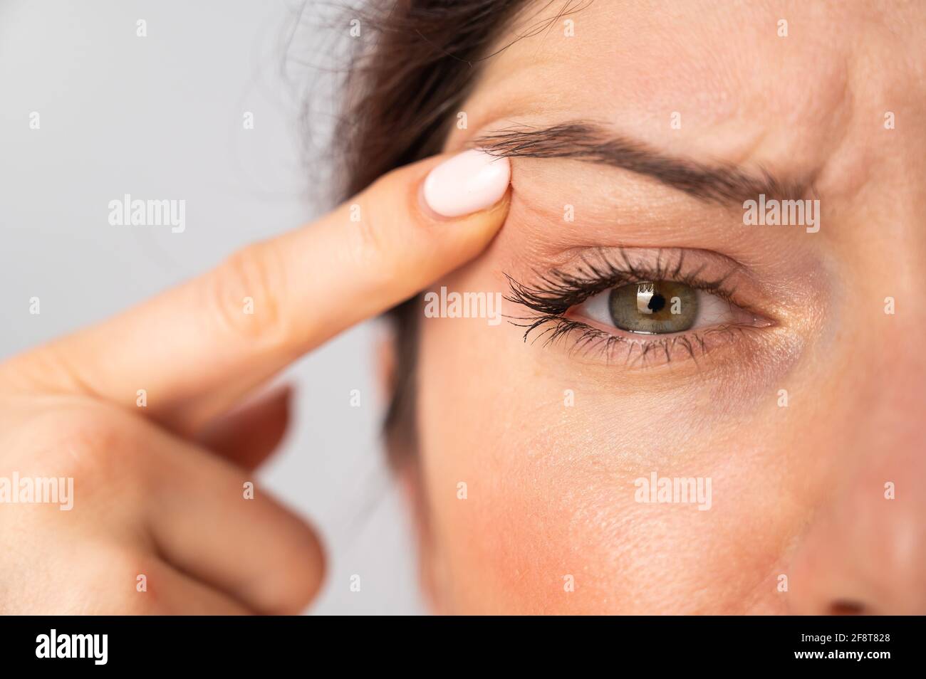 Close-up portrait of Caucasian middle-aged woman pointing to the ...