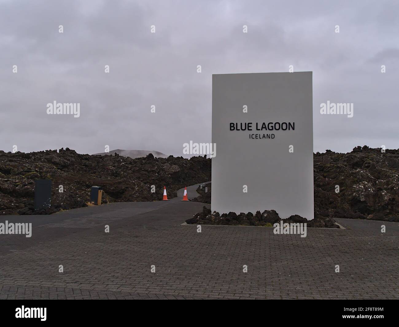 Sign at the entrance of tourist resort Blue Lagoon with lava rocks on ...