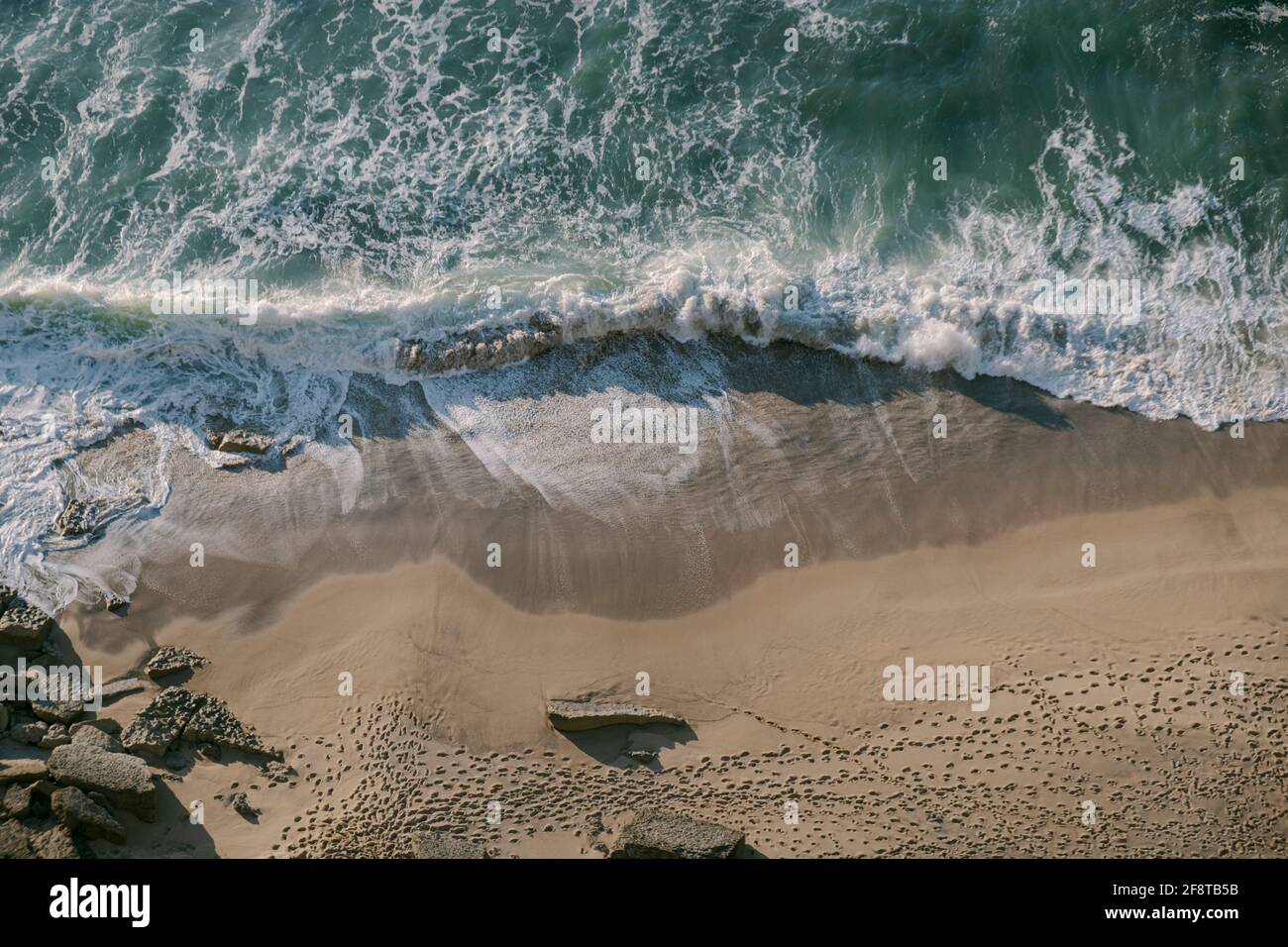 Aerial view of waves crashing into the beach Stock Photo - Alamy