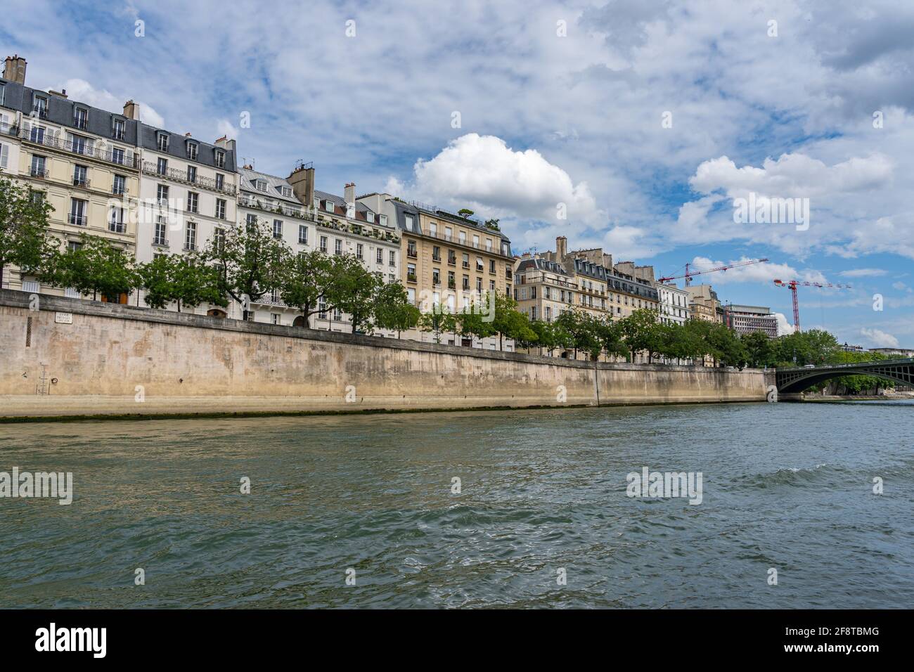 Tranquil scene of the Seine river with Haussmann buildings in Paris ...