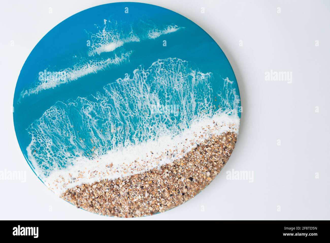 Round resin art painting with blue ocean waves and beach on white ...