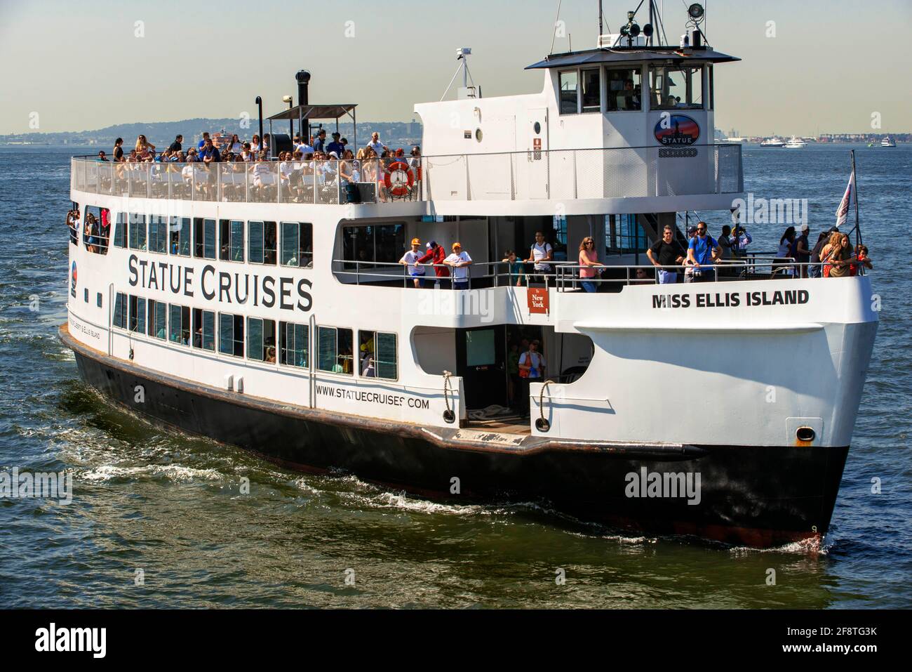 A boat going with tourist to The Statue of Liberty, New York. Statue ...