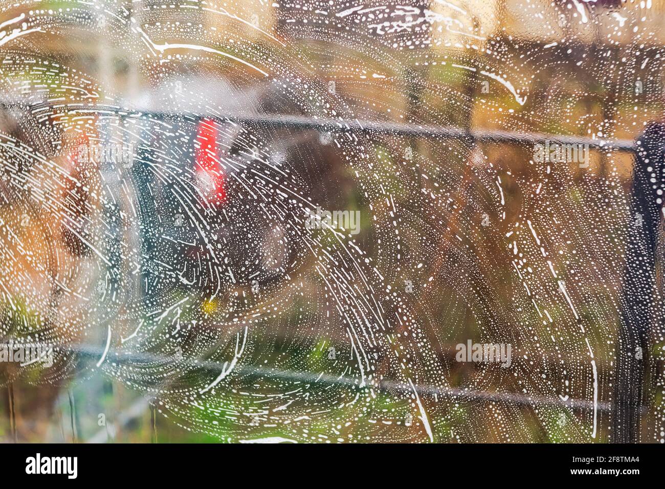 Soap foam on the window. The concept of cleanliness and comfort in the ...