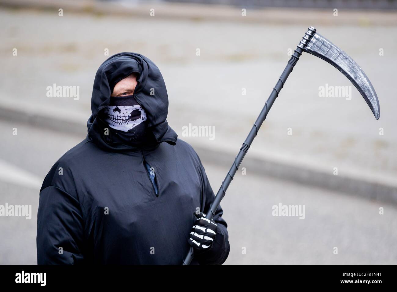 Berlin, Germany. 15th Apr, 2021. A participant in a grim reaper costume ...