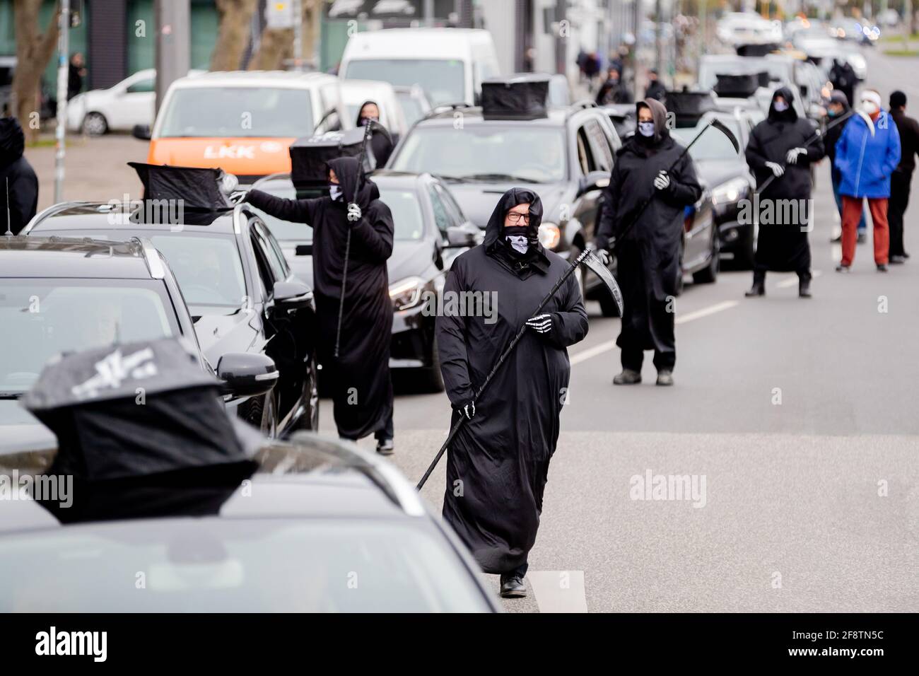 Berlin, Germany. 15th Apr, 2021. Participants in Grim Reaper costumes ...