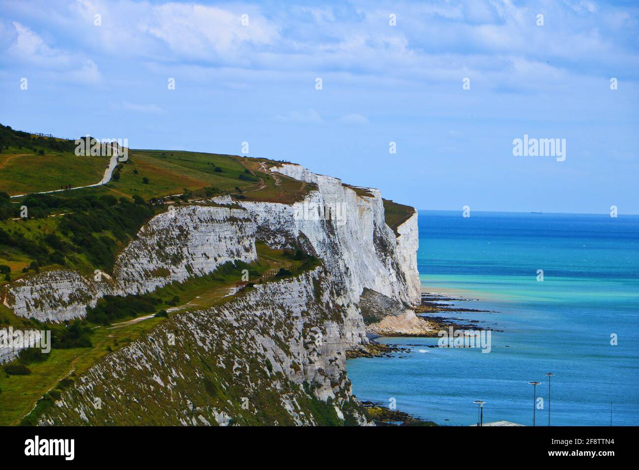 Aerial shot of a cliff on the seashore covered in greenery Stock Photo ...