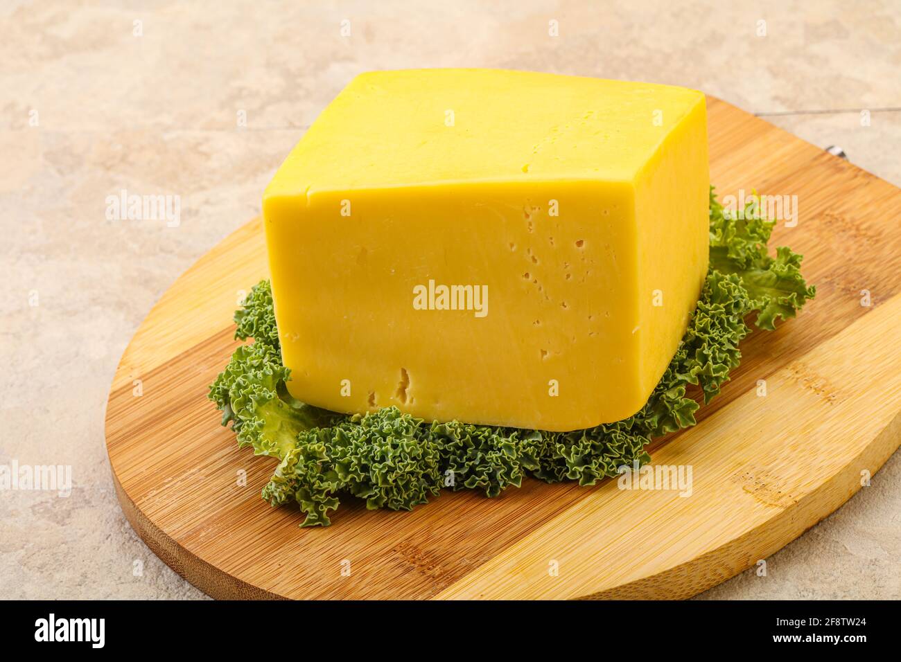 Yellow tilsiter cheese dairy product brick Stock Photo - Alamy