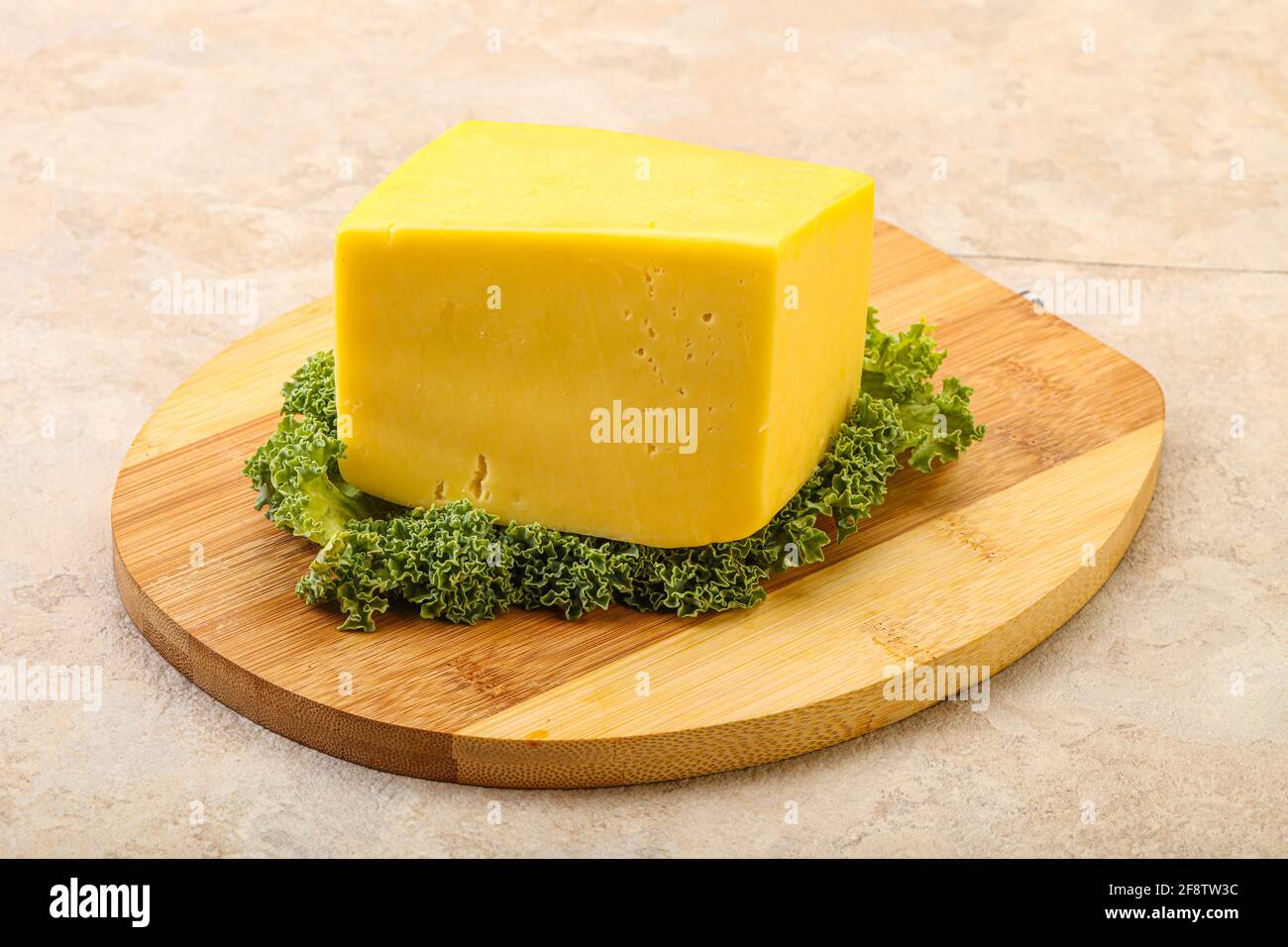 Yellow tilsiter cheese dairy product brick Stock Photo - Alamy