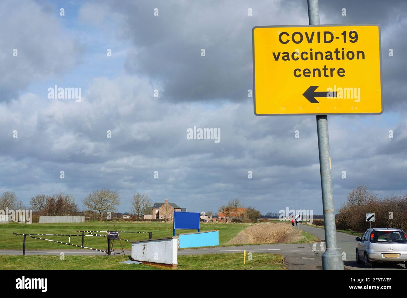 Direction sign for COVID 19 vaccination centre and several blanked out ...