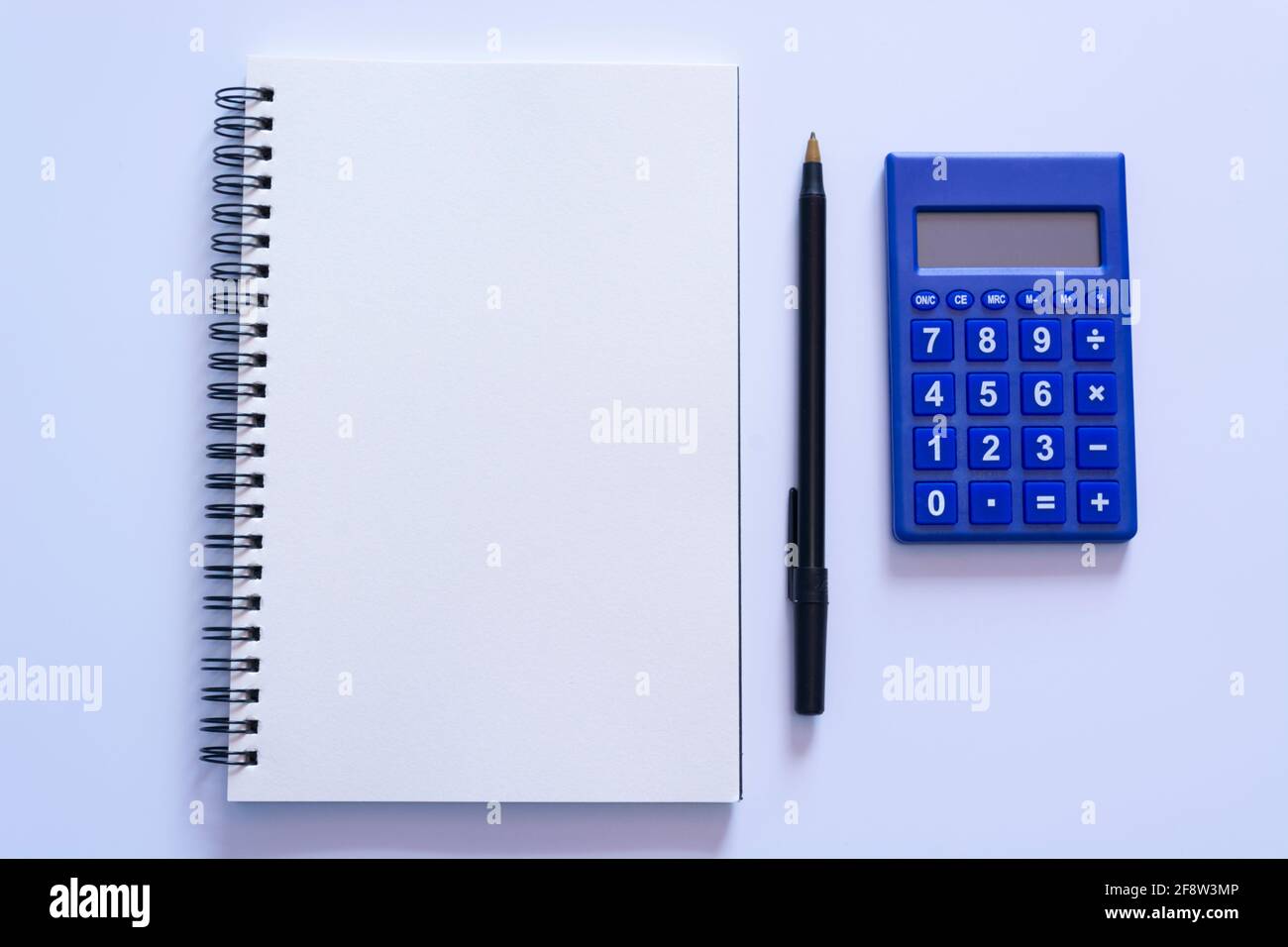 Top view of note pad, pen, and calculator Stock Photo - Alamy