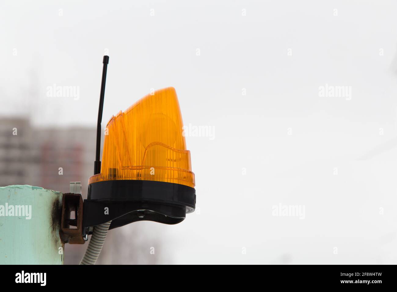 Close-up of a yellow beacon with an antenna for transmitting an alarm ...