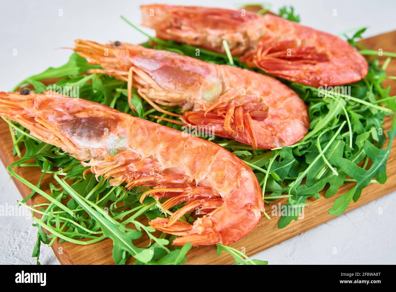 Fresh shrimps with rucola. Red raw prawns, close up. Seafood background ...
