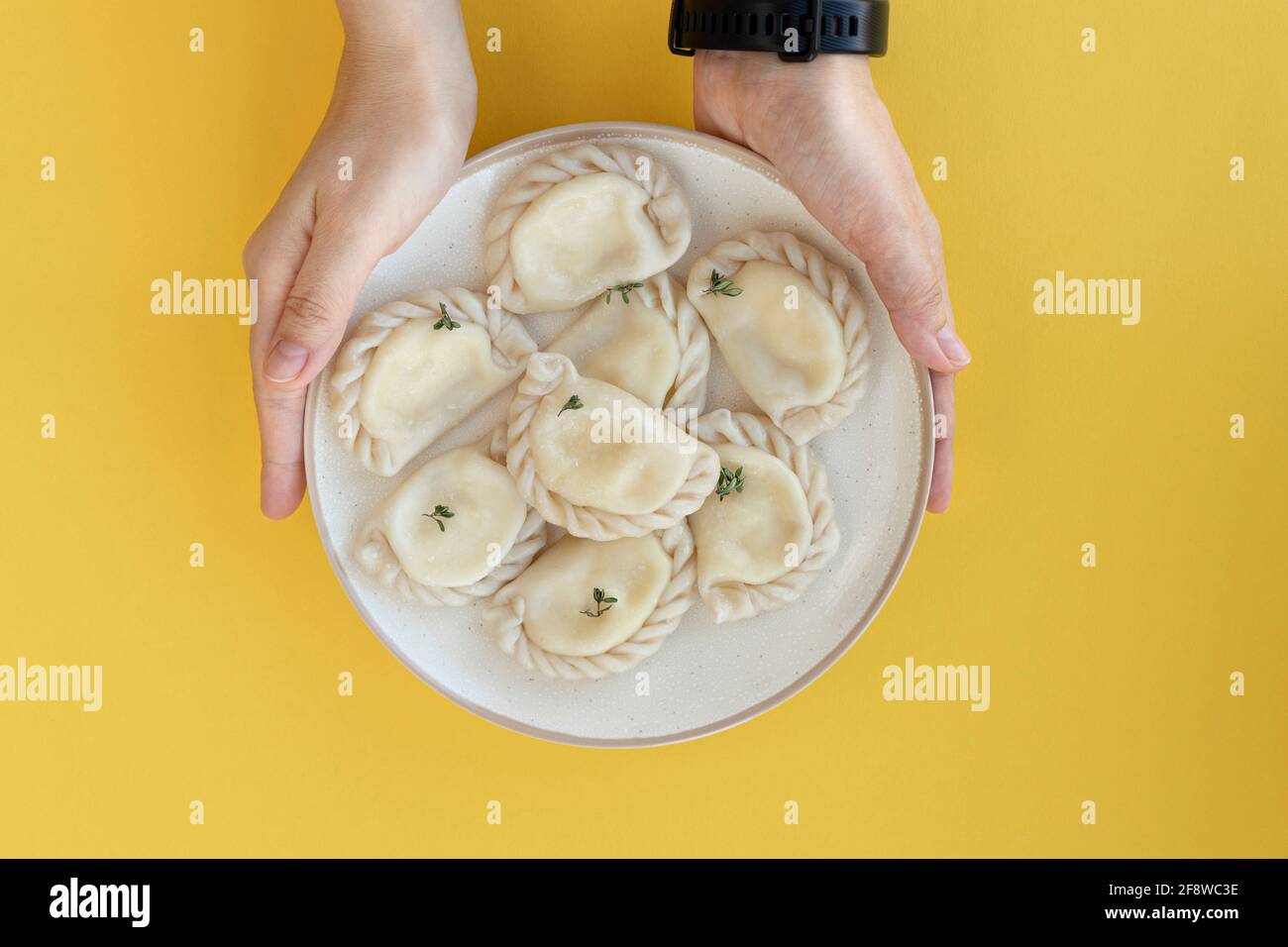 female hands serving delicious, fresh, homemade italian ravioli on a ...