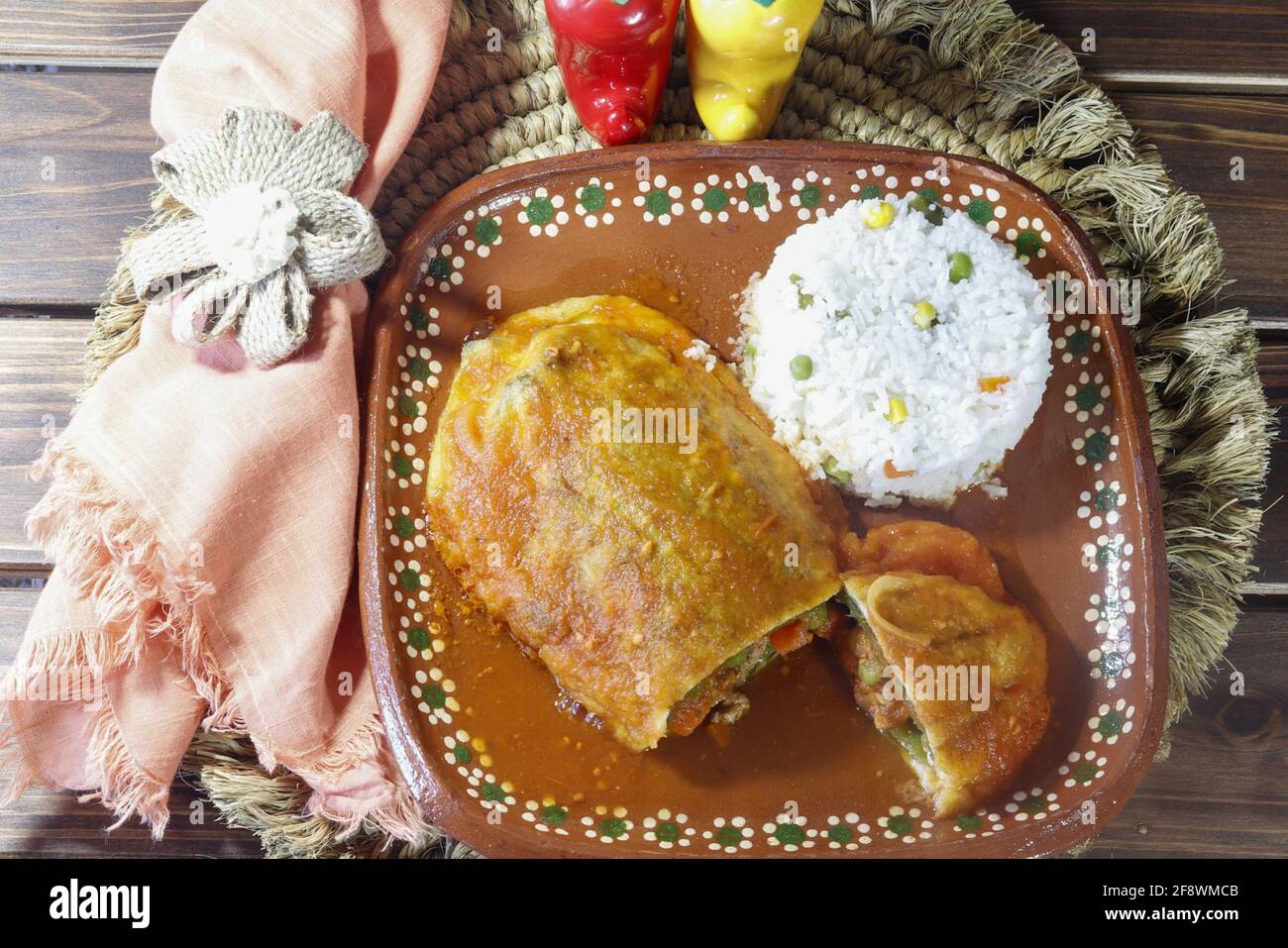 Mexican dish chile relleno with picadillo, tomato sauce, ground meat ...