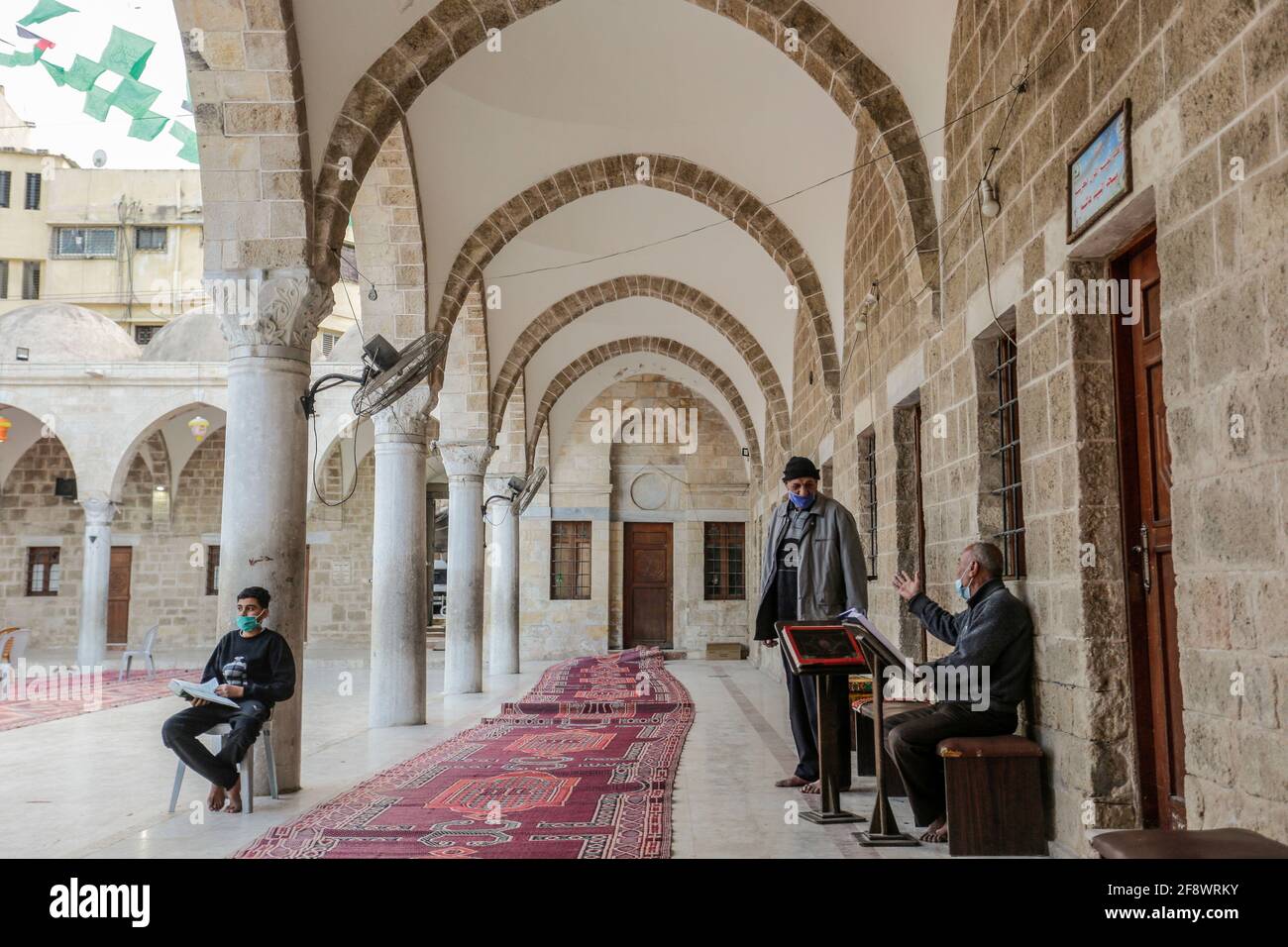 Muslim men read a copy of the Holy Qur’an at the Medieval Al-Sayed Hashem Mosque during the ...