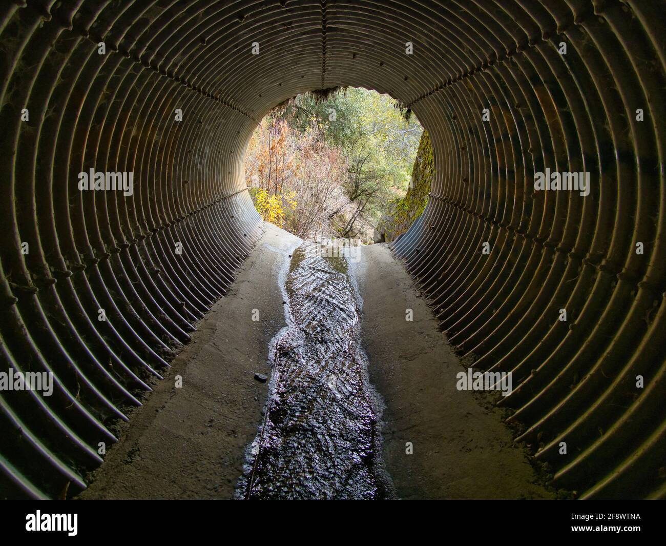 Shot of looking through metal drainage pipe Stock Photo - Alamy
