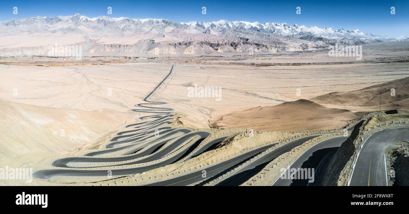 aerial view of the mountain road full of hairpin bends that connect ...