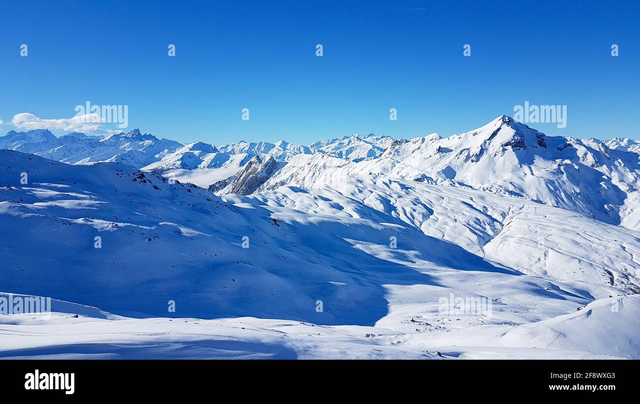 Sunny view over the peaks of white mountains of the French Alps from ...