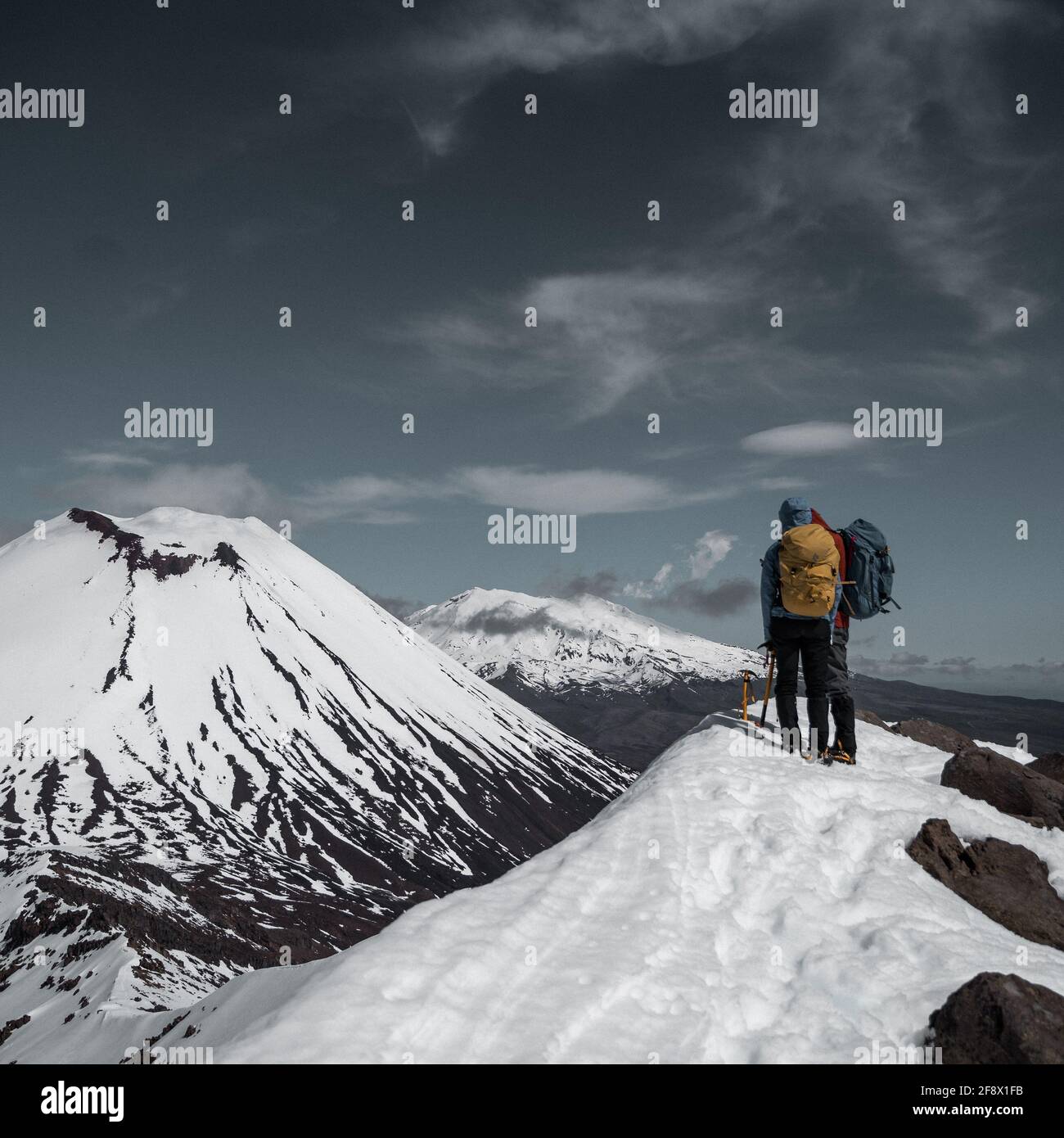 Two tourists on snowy mountains Stock Photo - Alamy