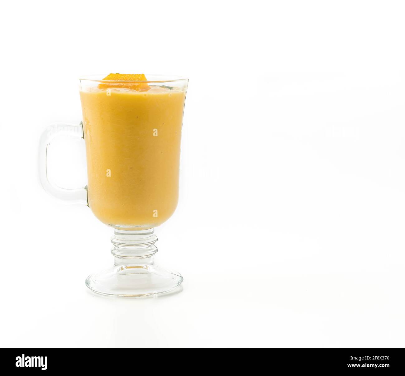 fresh mango smoothie on white background Stock Photo - Alamy
