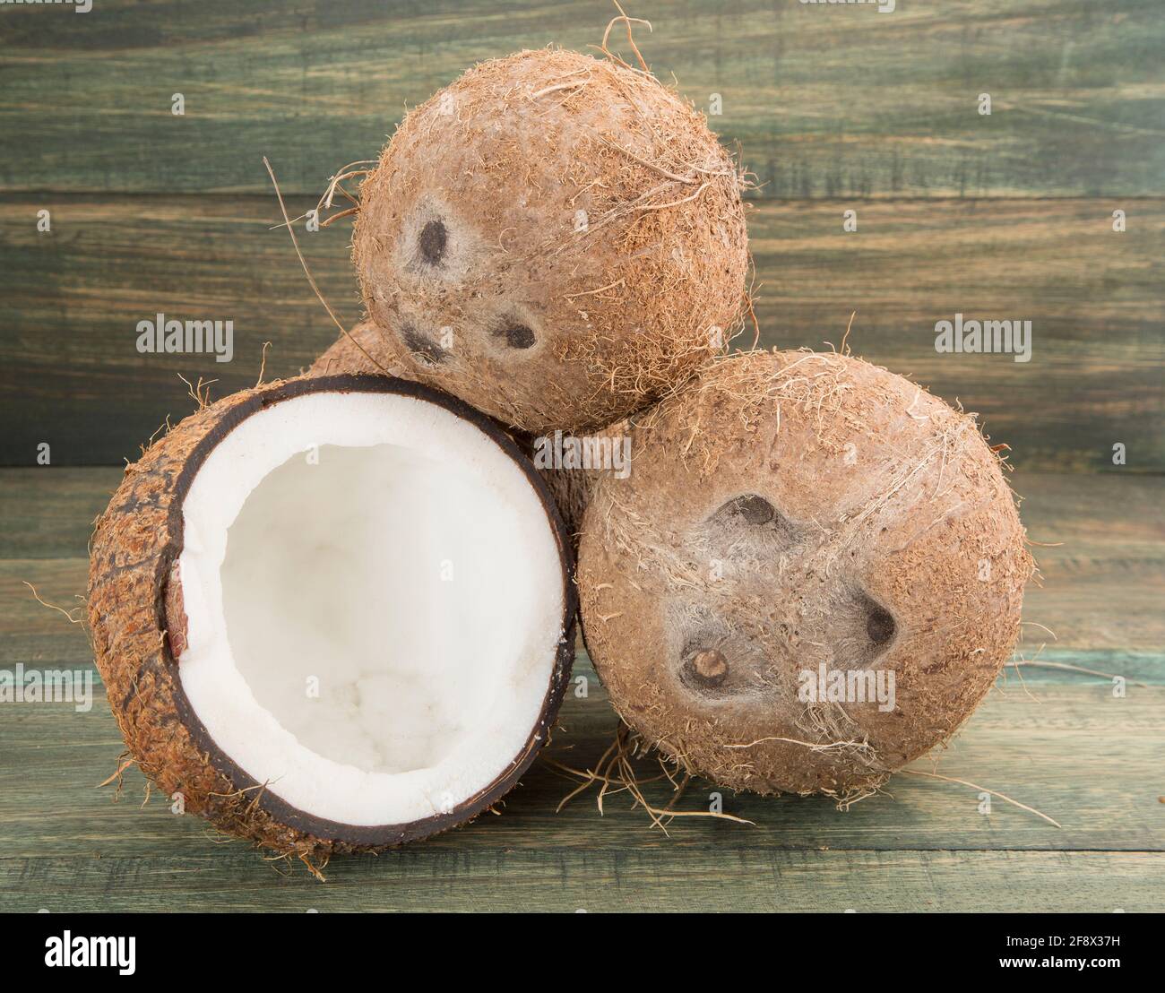 Natural coconut on the wooden background - Cocos nucifera Stock Photo ...