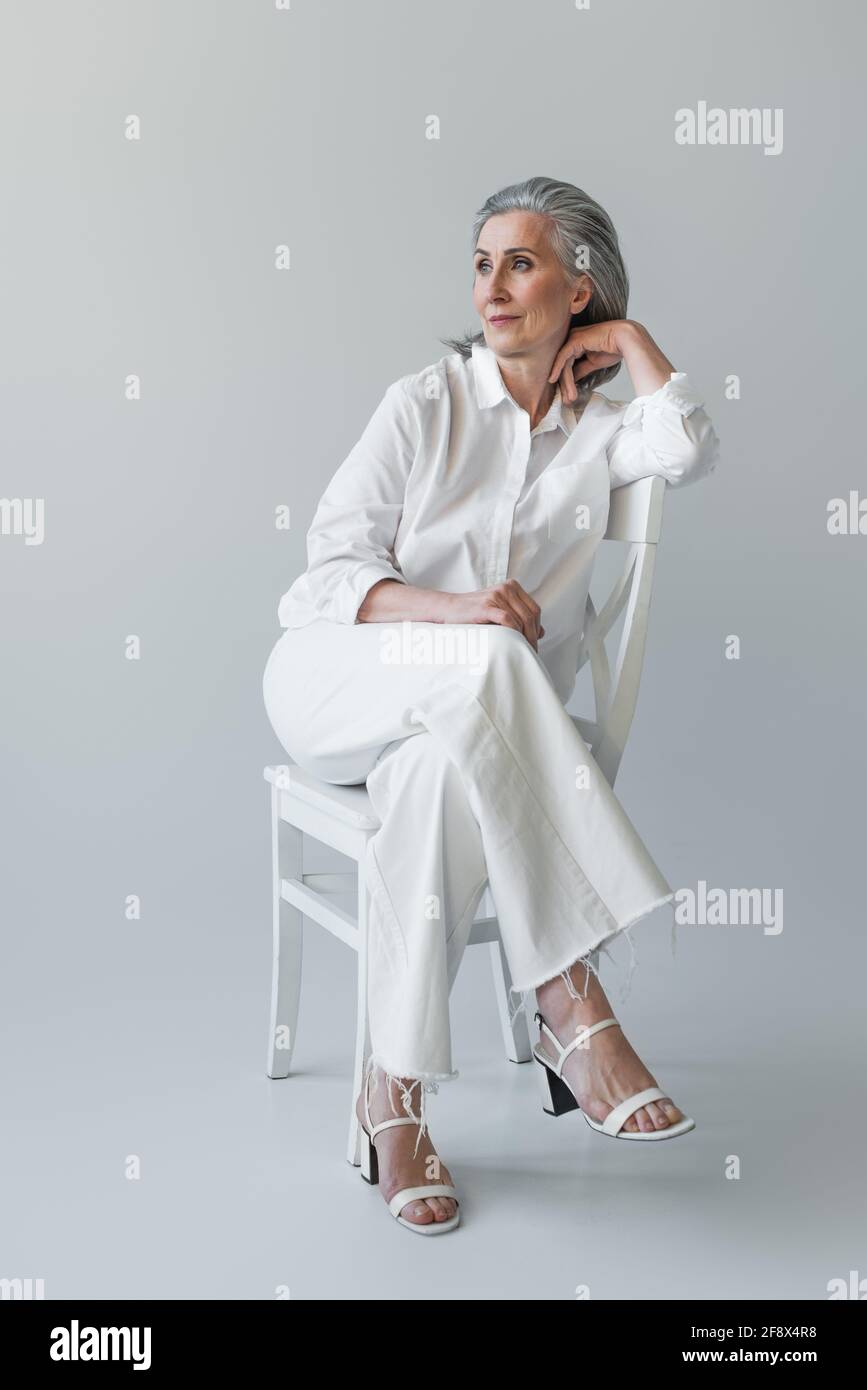 Mature woman crossed legs hi-res stock photography and images - Alamy