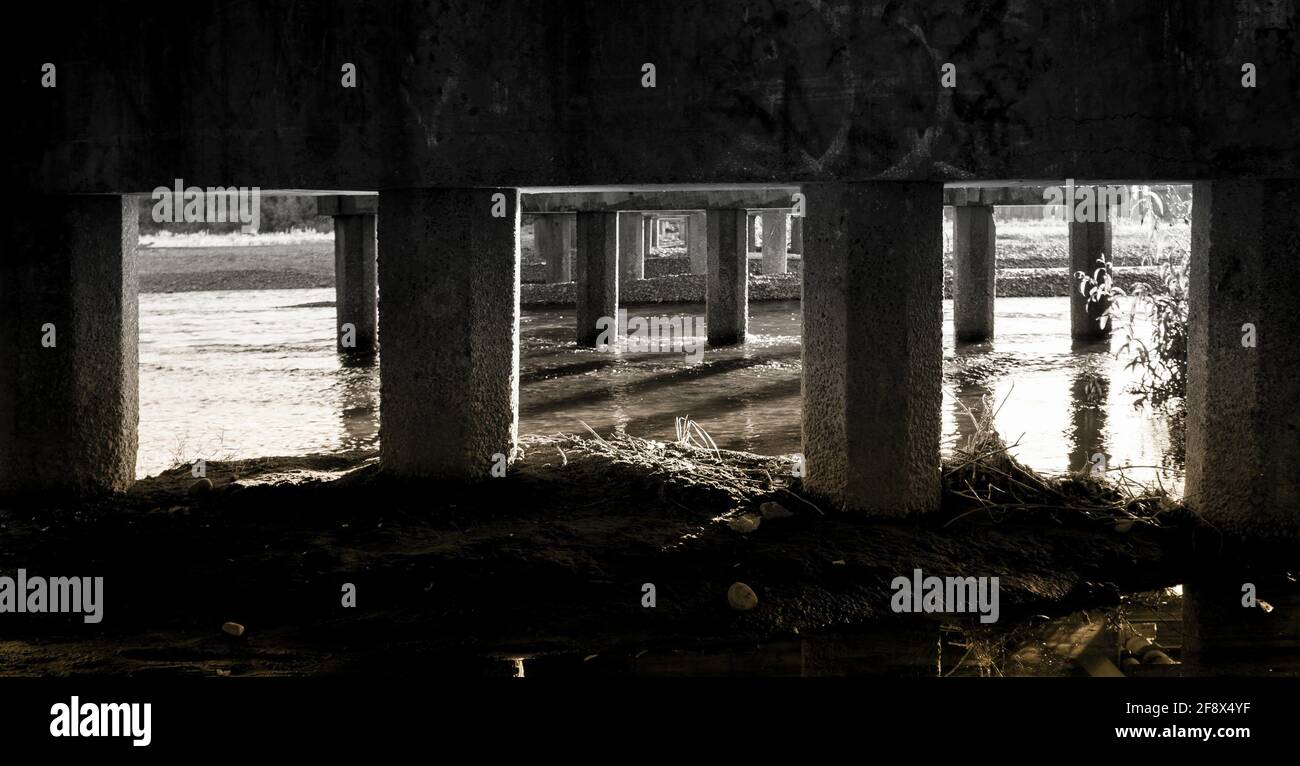 Closeup shot of trash stacked on the concrete pillars under a bridge ...