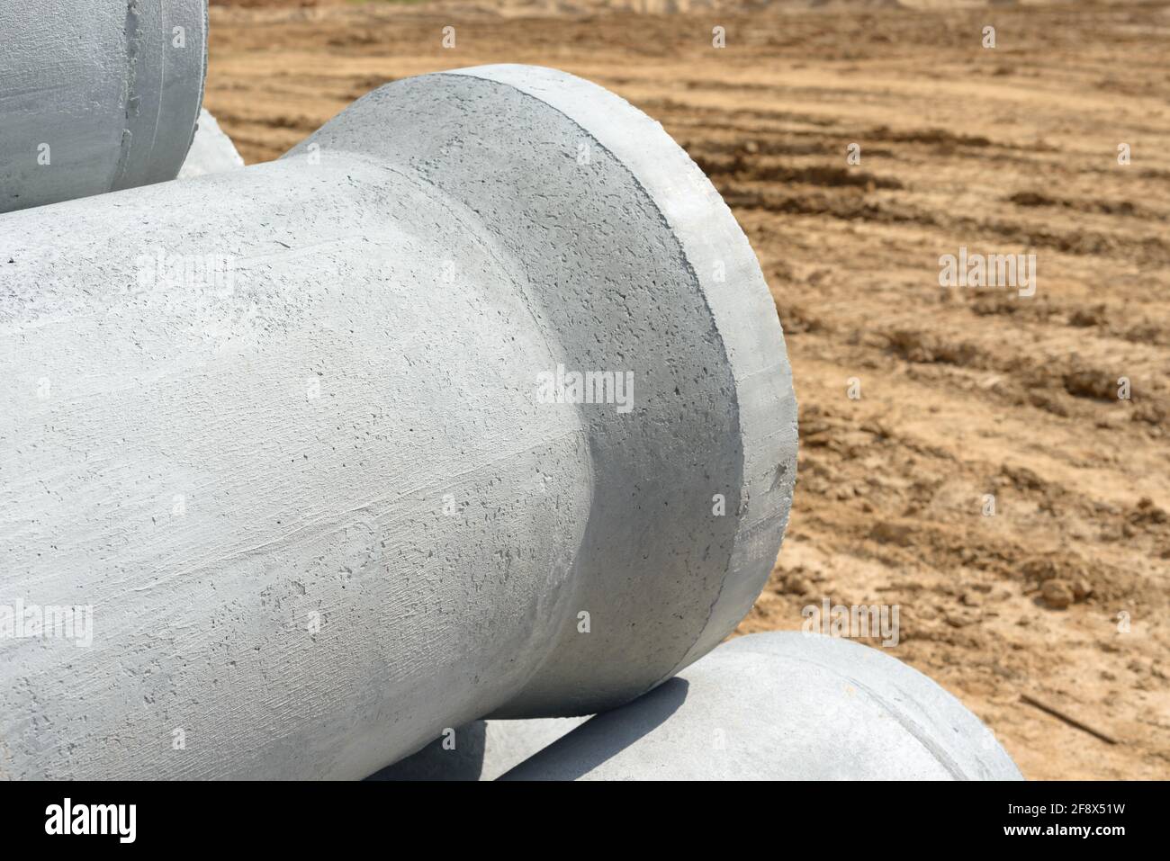 Industrial concrete drainage pipes stacked for construction. New tubes ...