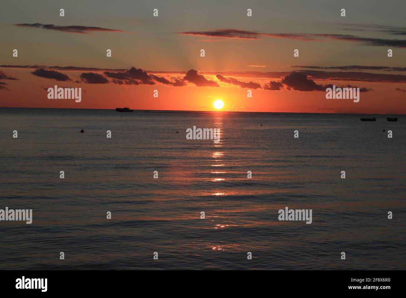 Amazing red sun over the sea. Sunset seen from the beach in Malta Stock ...