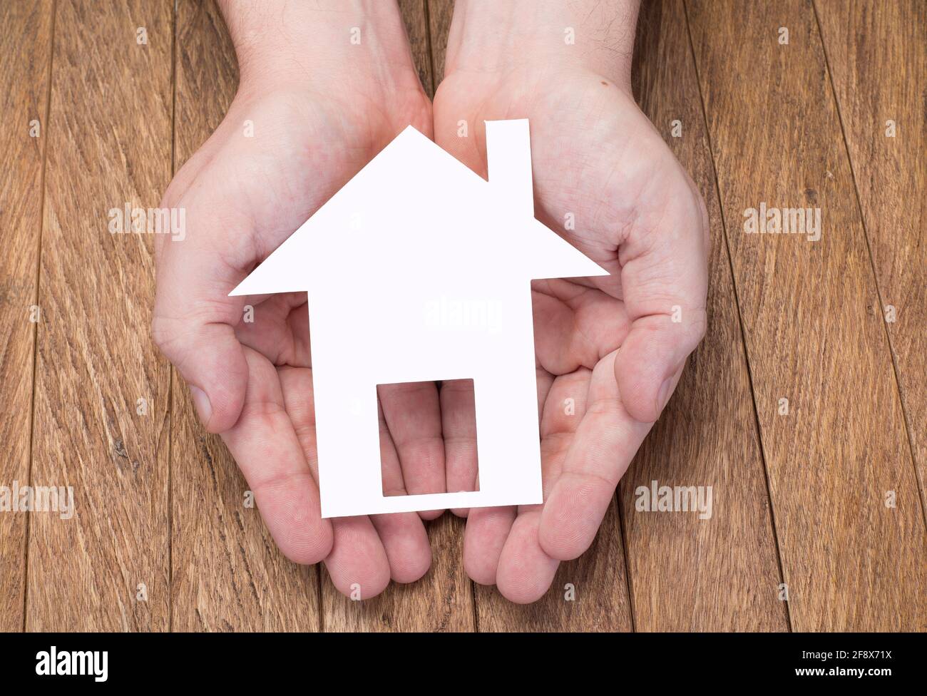 Hands protecting house hi-res stock photography and images - Alamy