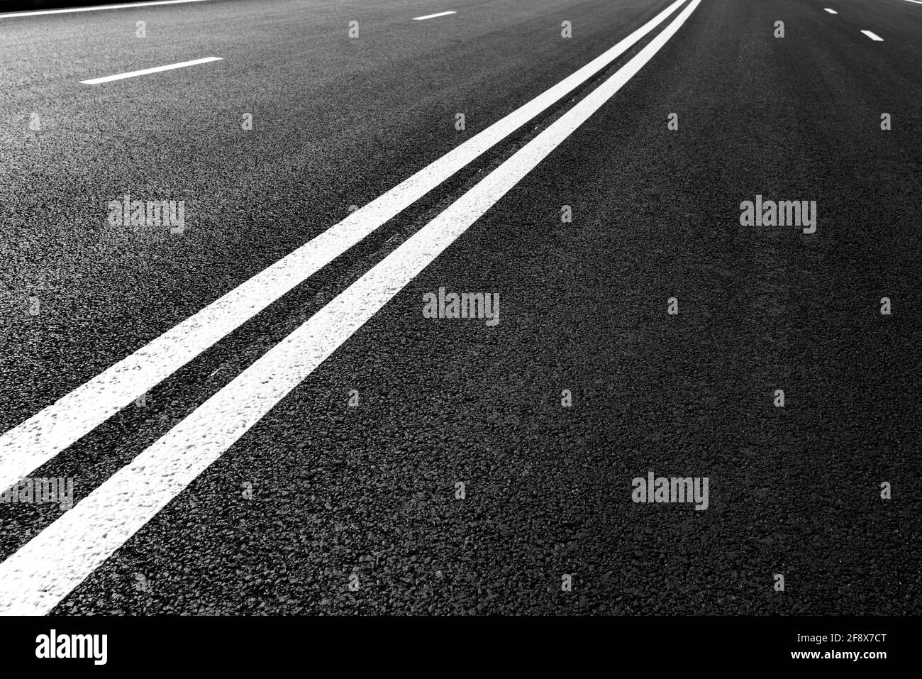 Asphalt road with marking lines white stripes Stock Photo - Alamy