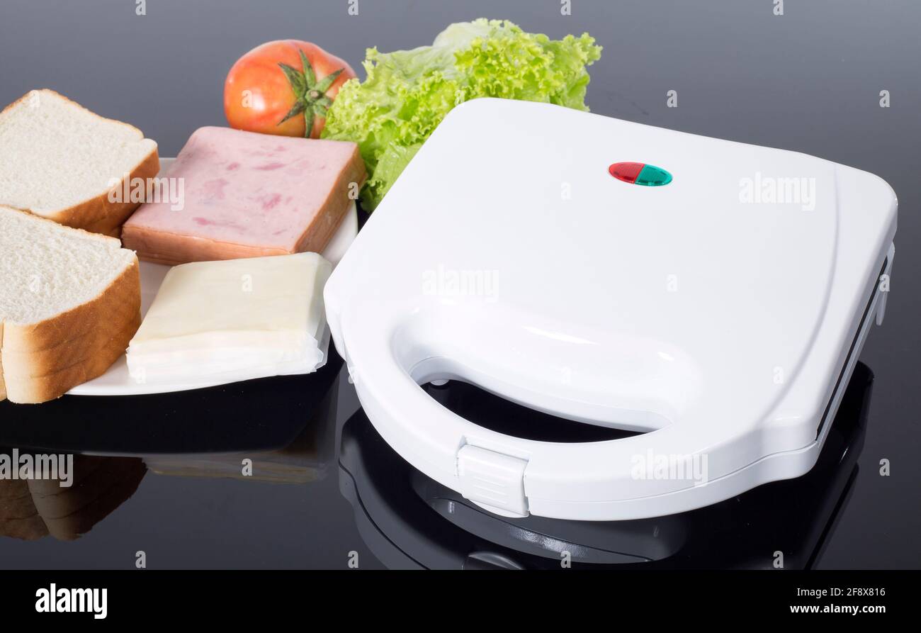 Open sandwich toaster with ingredients on white background Stock Photo ...