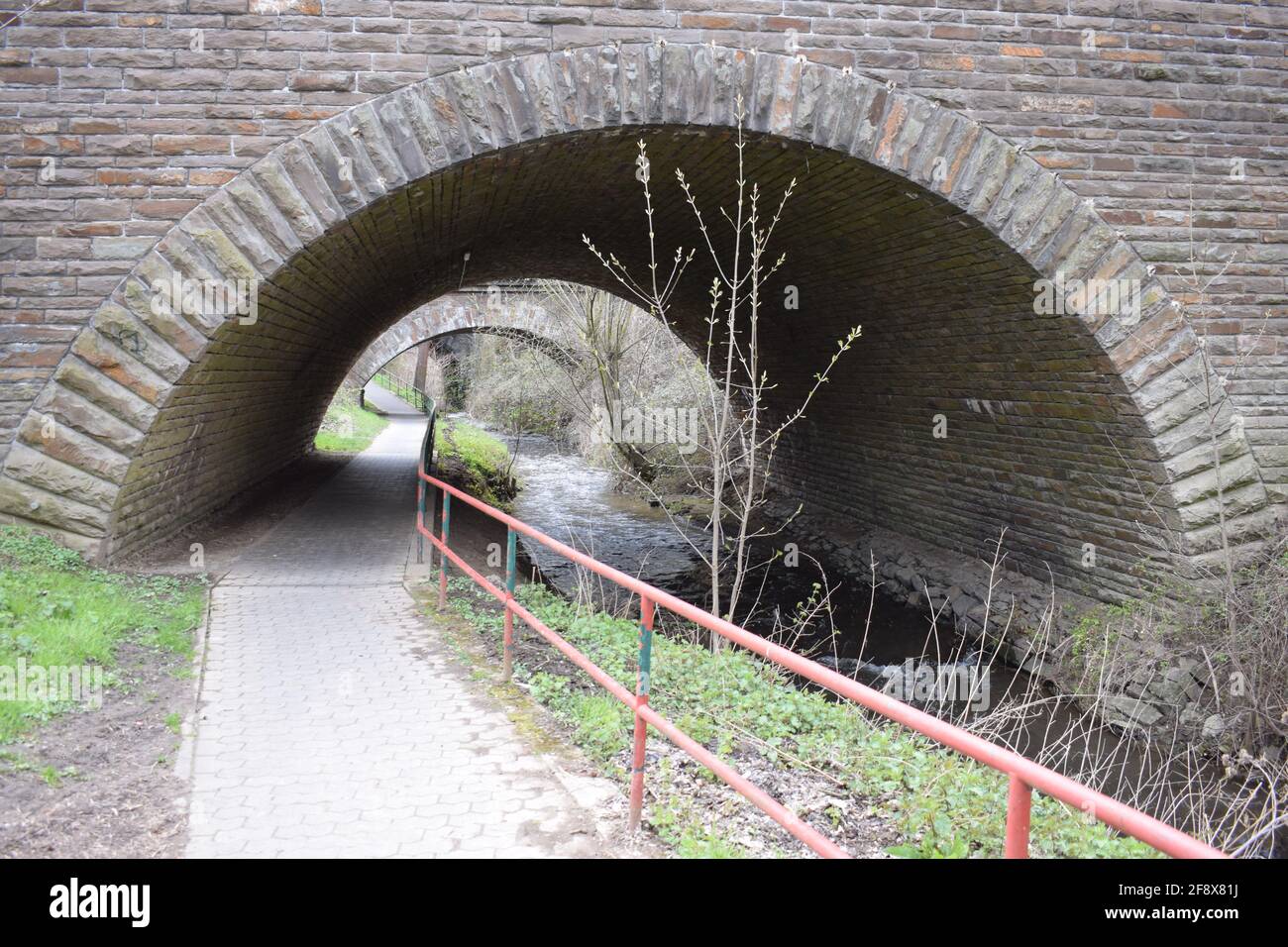 tunnel with river and small path Stock Photo - Alamy